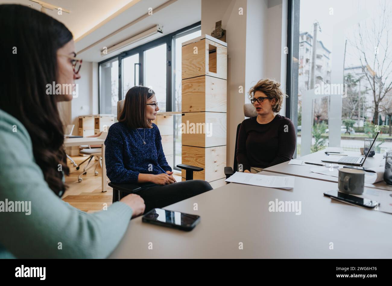 A contemporary office setting with a diverse group of professionals ...