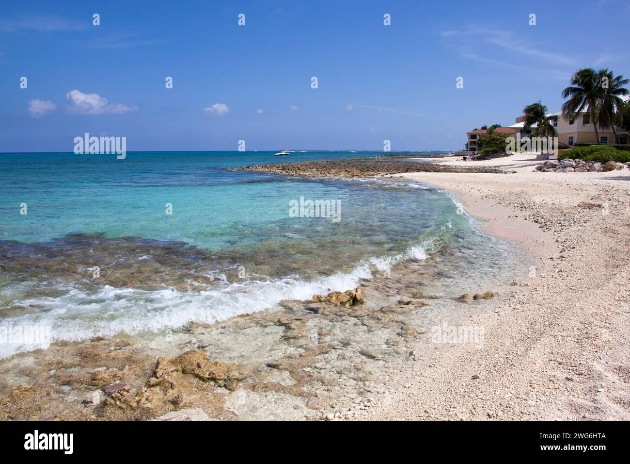 The scenic view of famous Seven Mile Beach with little waves on Grand ...