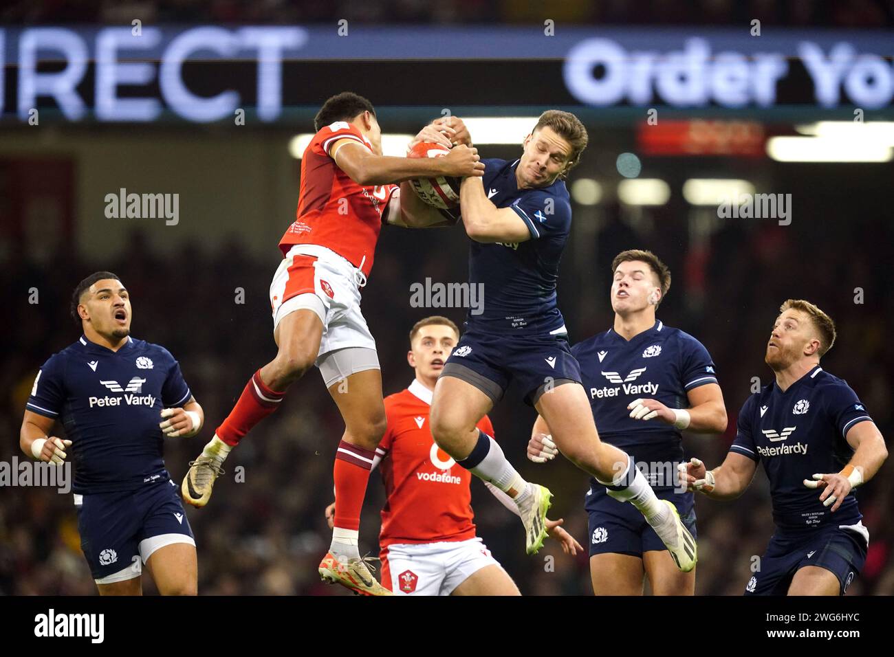 Wales' Rio Dyer and Scotland's Kyle Rowe attempt to claim the ball ...