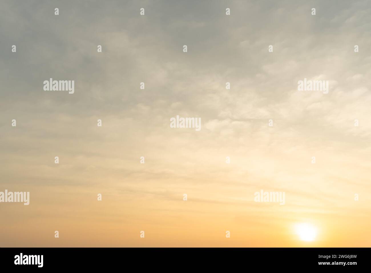 The sun is setting in evening at the sea with orange sky and strange ...