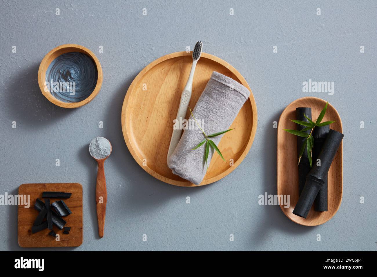 Top view of a activated charcoal mask bowl, two trays of black bamboo ...