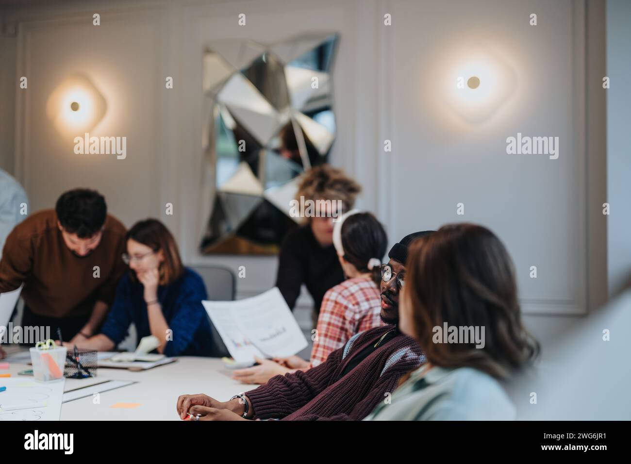 Focused group of professionals collaborating in a well-lit office ...