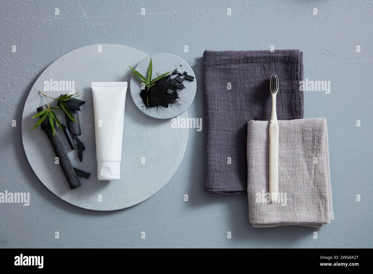 Flat lay of cosmetic tube with bamboo activated charcoal. Dental care ...