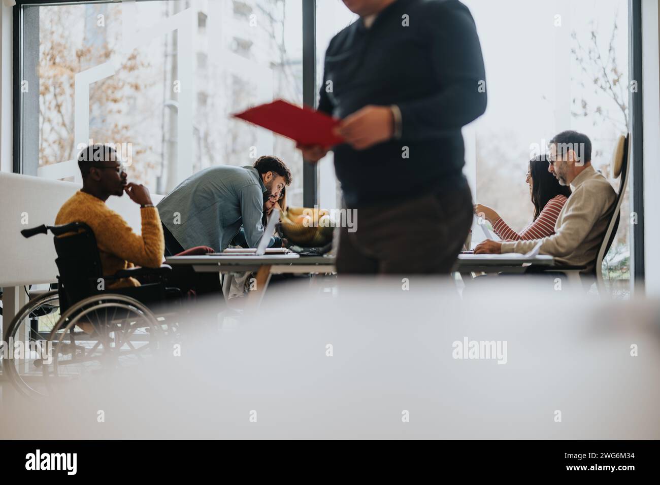 Inclusive office setting with diverse team members, featuring a person ...