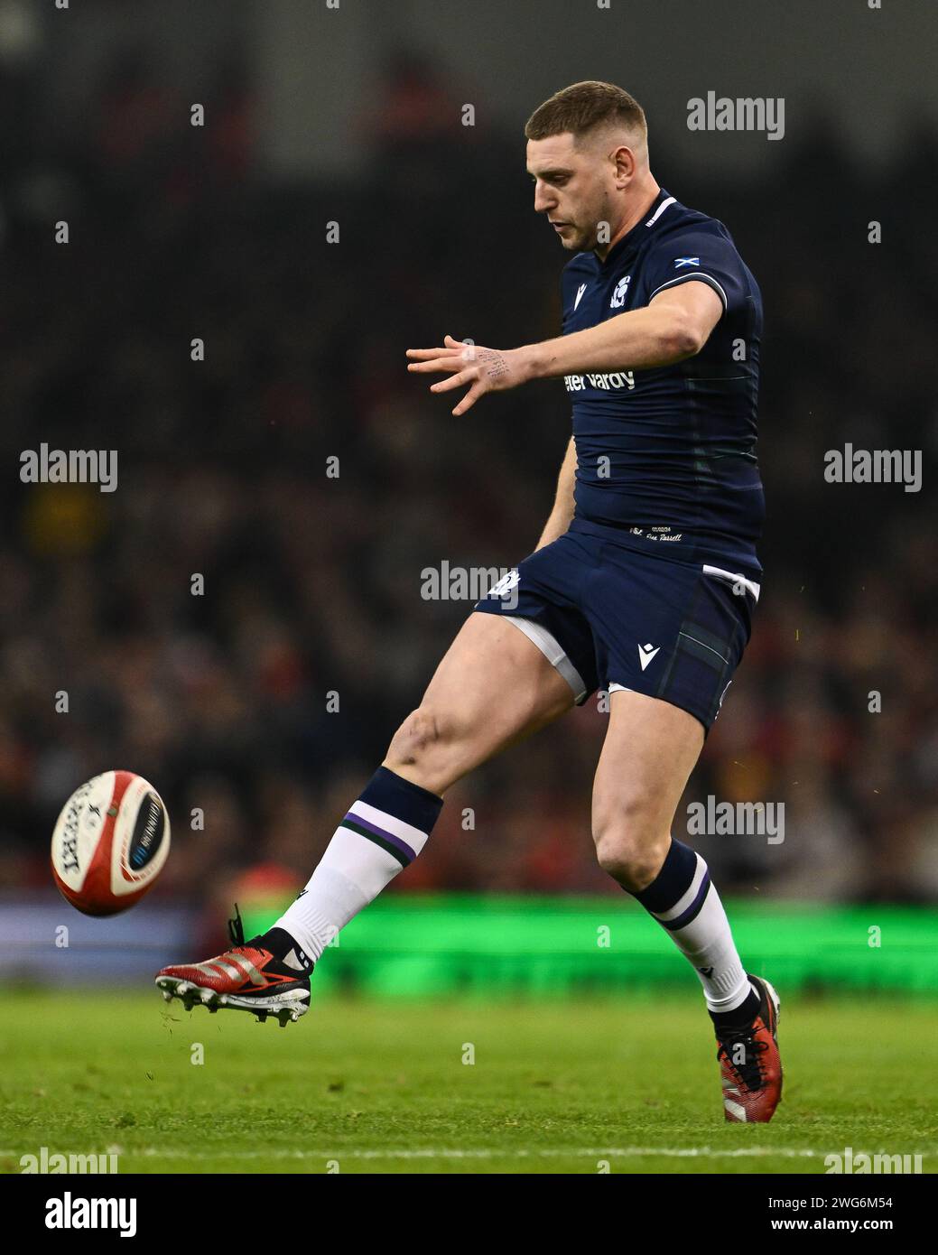 Finn Russell of Scotland kicks ahead during the 2024 Guinness 6 Nations ...