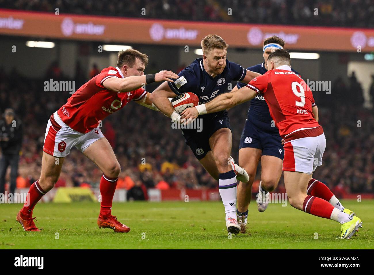 Kyle Steyn of Scotland is tackled by Gareth Davies of Wales during the ...
