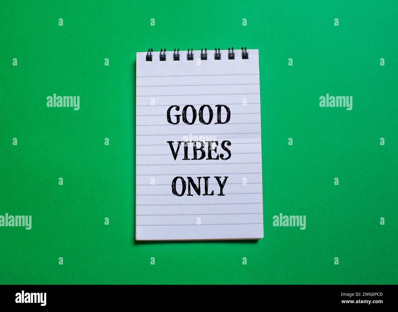 Good vibes only words written on notepad page with green background ...