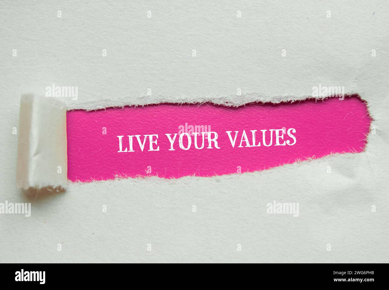 Live your values lettering on torn paper with pink background ...