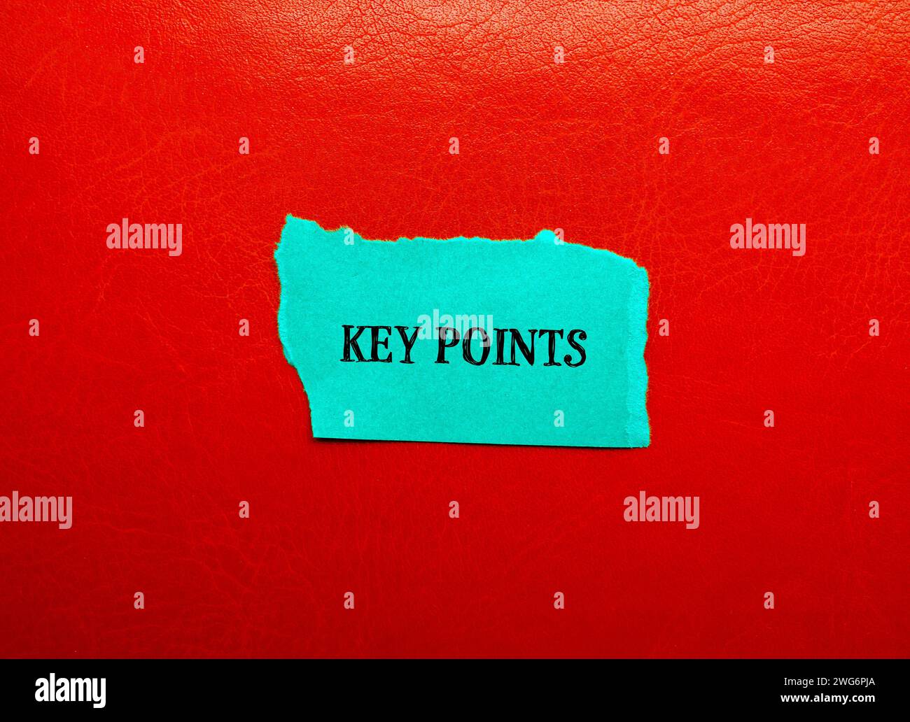 Key points lettering on ripped paper piece with red background ...