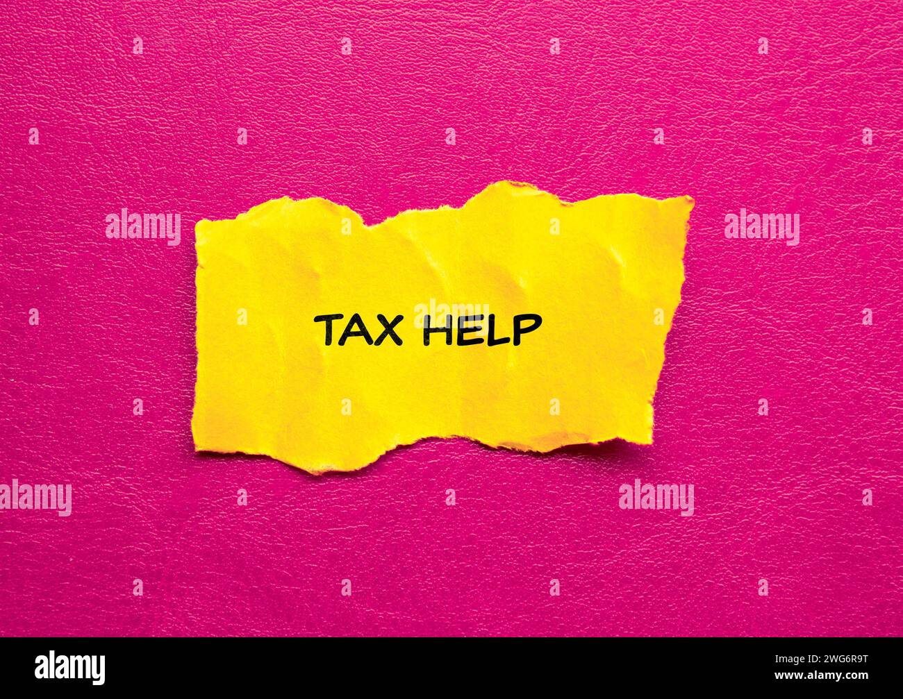 Tax help lettering on ripped paper piece with pink background ...
