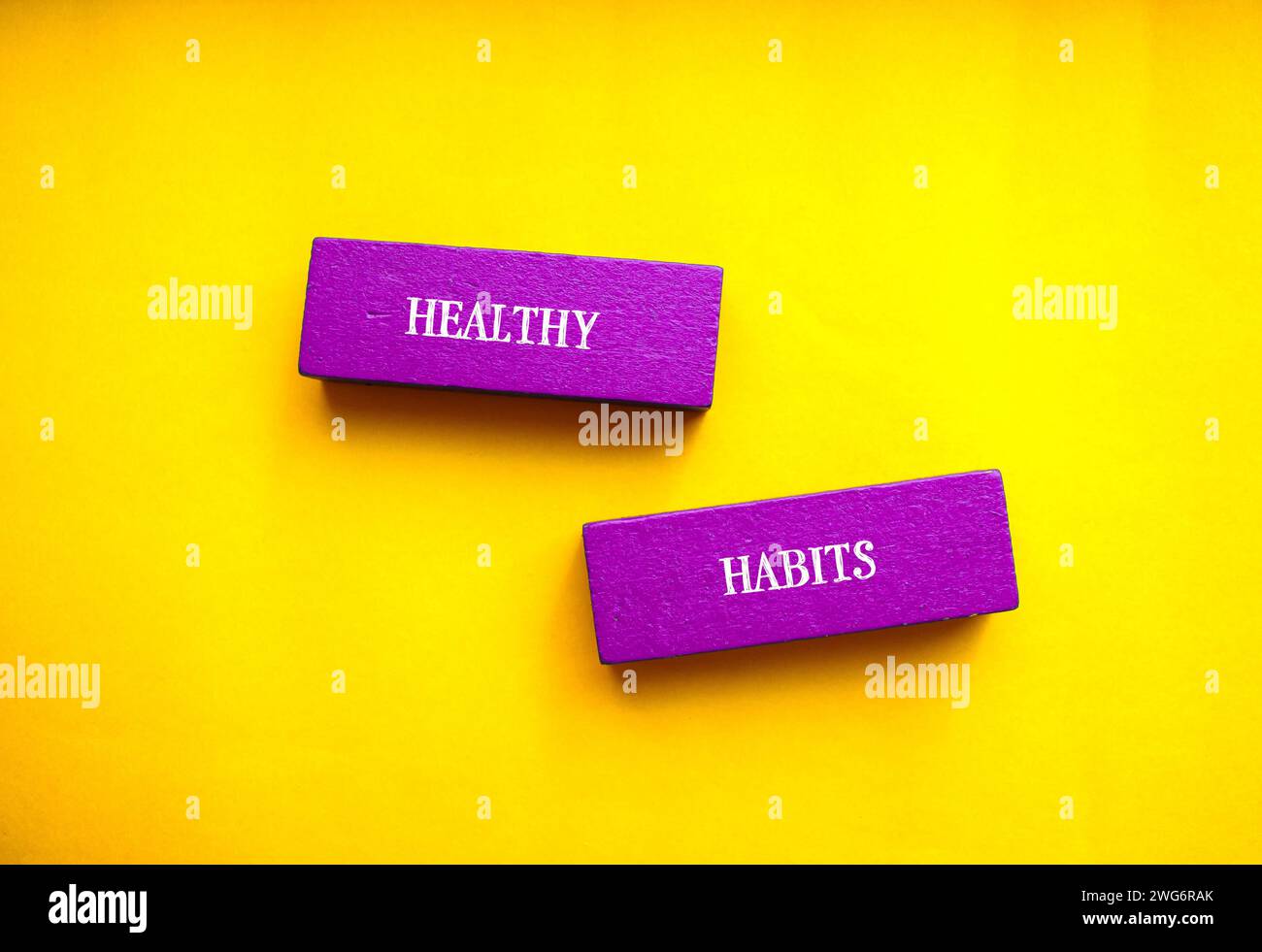 Healthy habits lettering on purple wooden block with yellow background ...