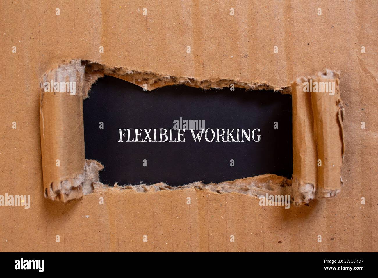 Flexible working lettering on ripped cardboard paper with black ...