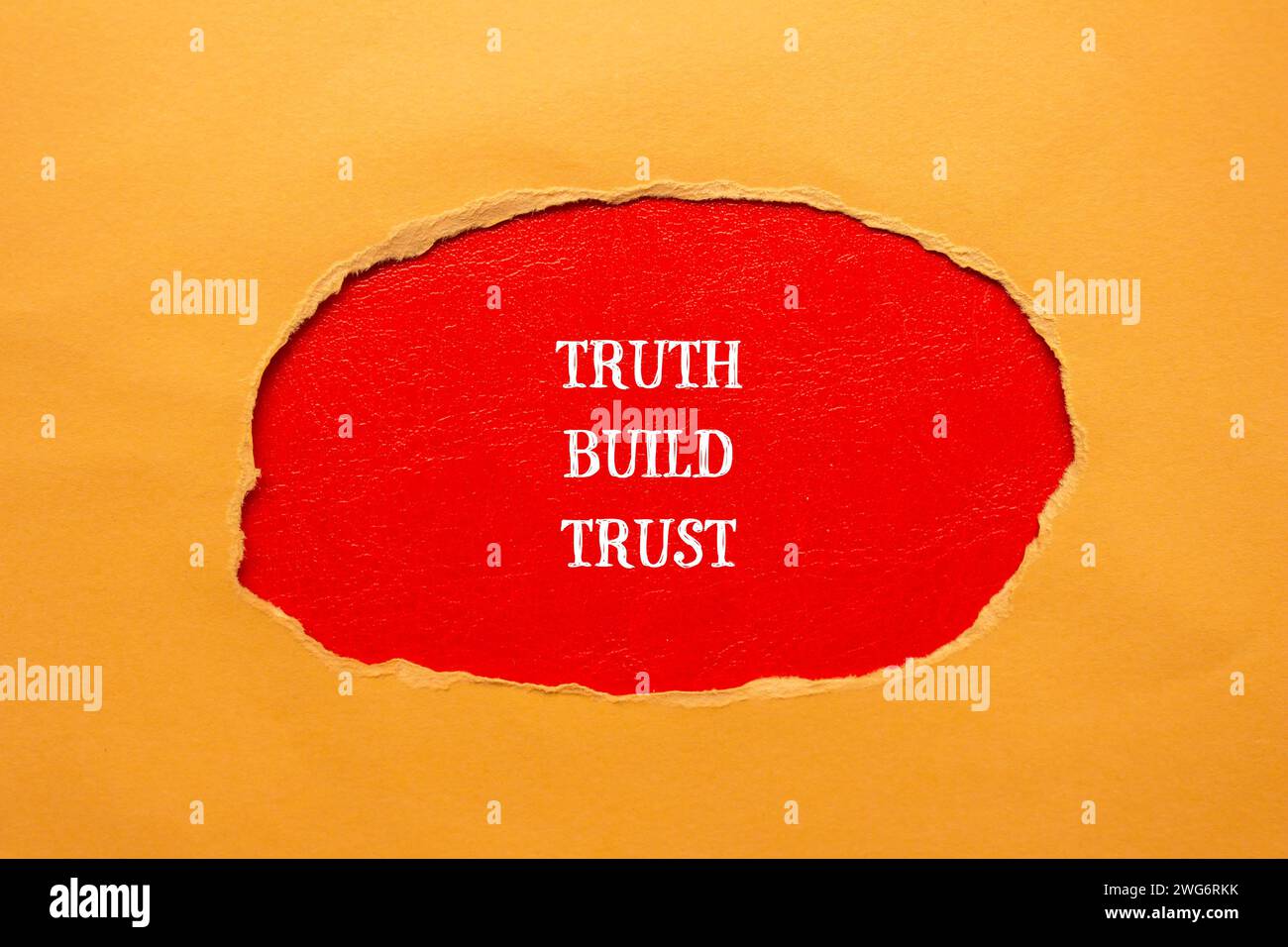 Truth build trust lettering on ripped orange paper with red background ...