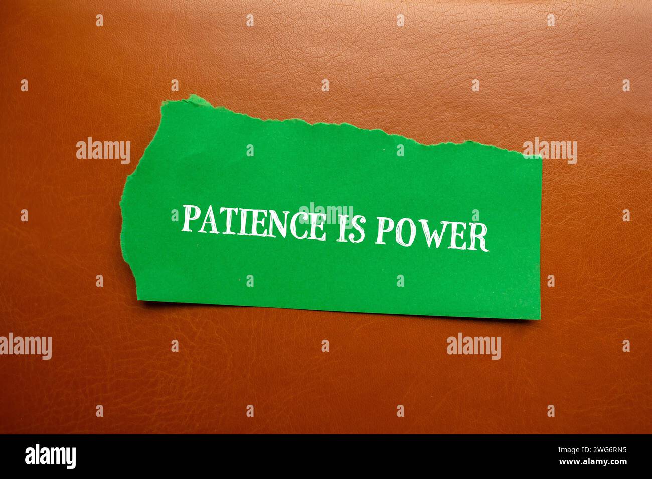 Patience is power lettering on ripped paper with brown background ...
