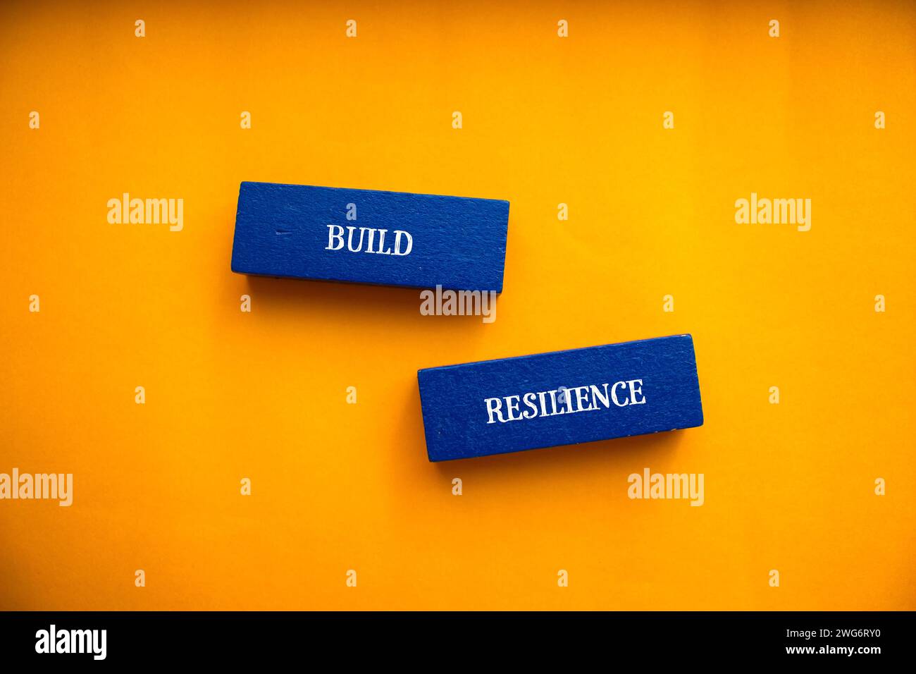 Build resilience lettering on wooden block with orange background ...