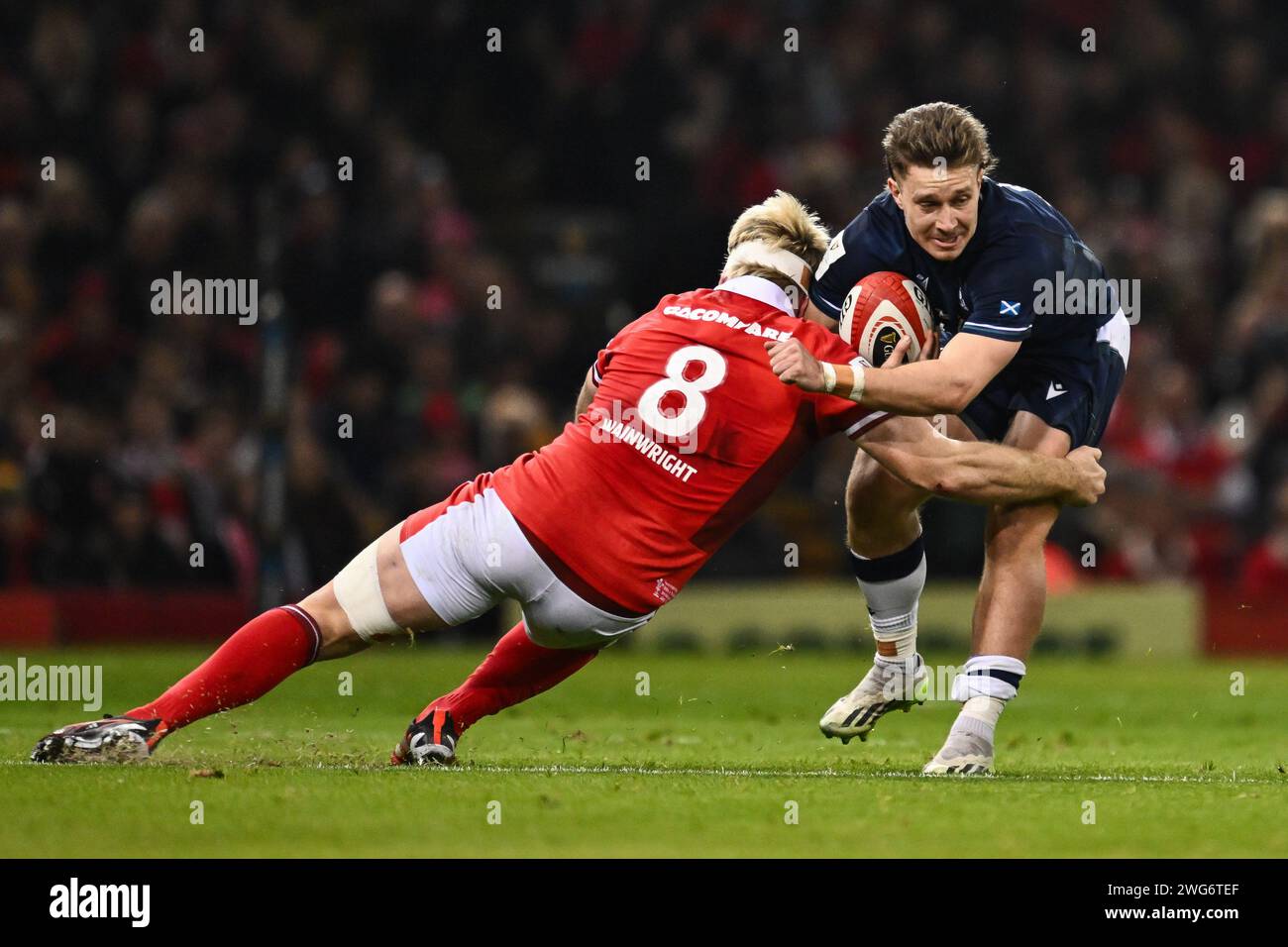 Kyle Rowe of Scotland is tackled by Aaron Wainwright of Wales during ...