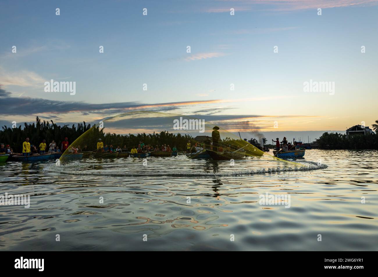 An old fisherman is throwing a net to catch fish Stock Photo - Alamy