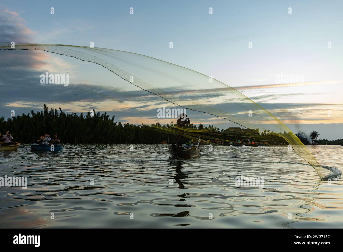An old fisherman is throwing a net to catch fish Stock Photo - Alamy