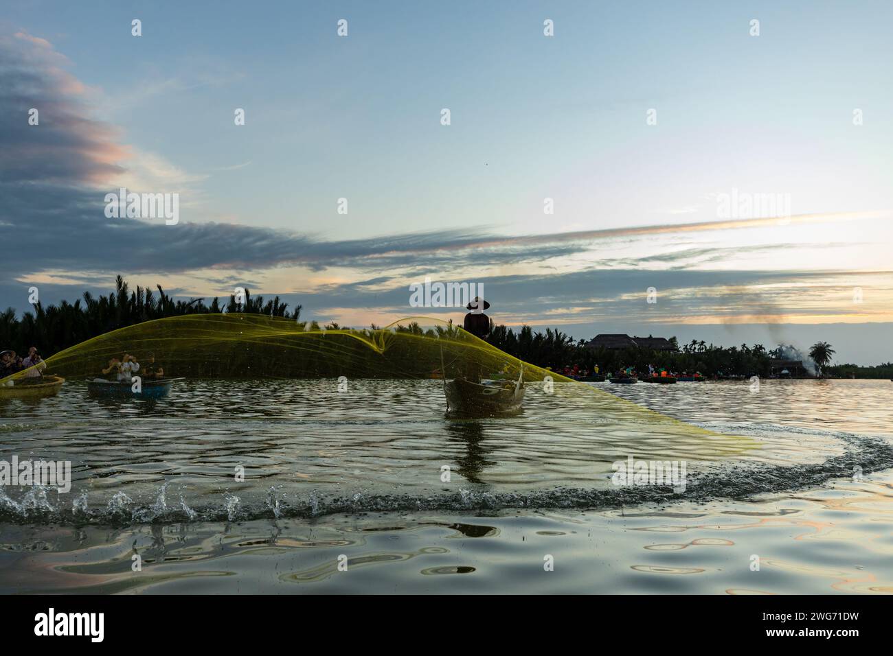 An old fisherman is throwing a net to catch fish Stock Photo - Alamy