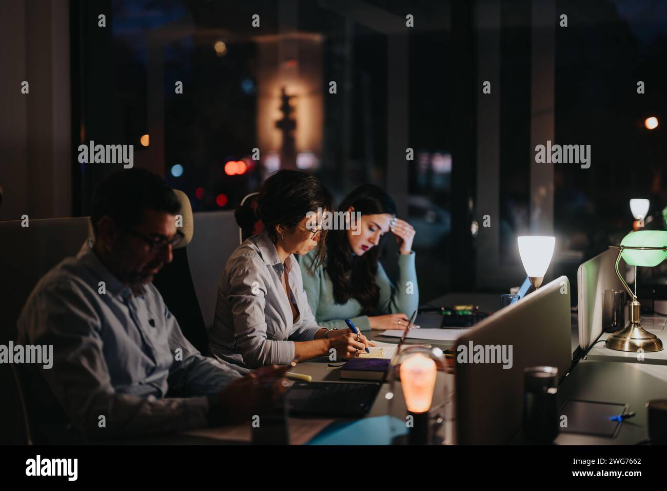 A focused group of multigenerational people in a business meeting ...