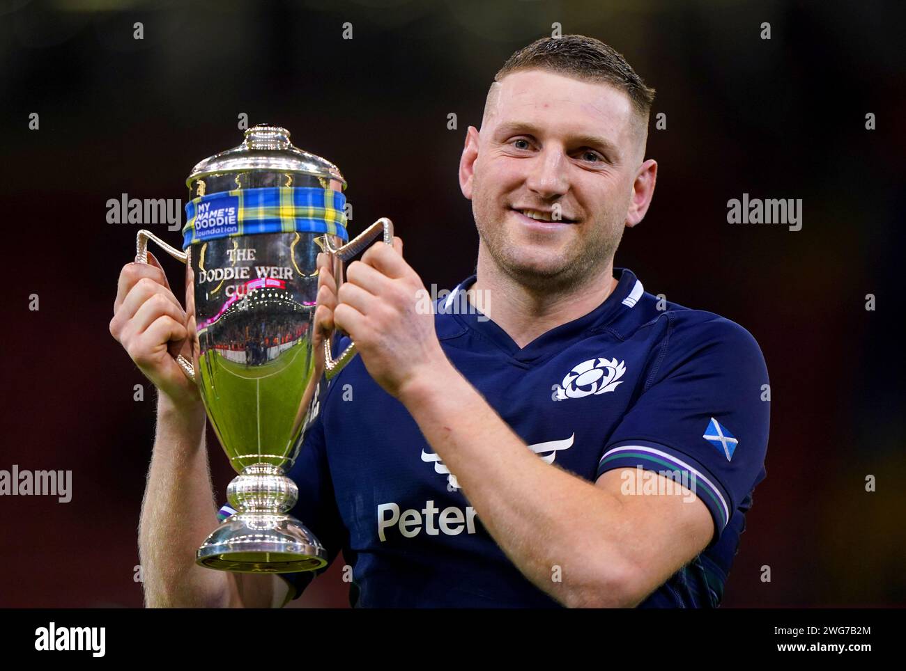 Scotland's Finn Russell celebrates with the Doddie Weir Cup at the end ...