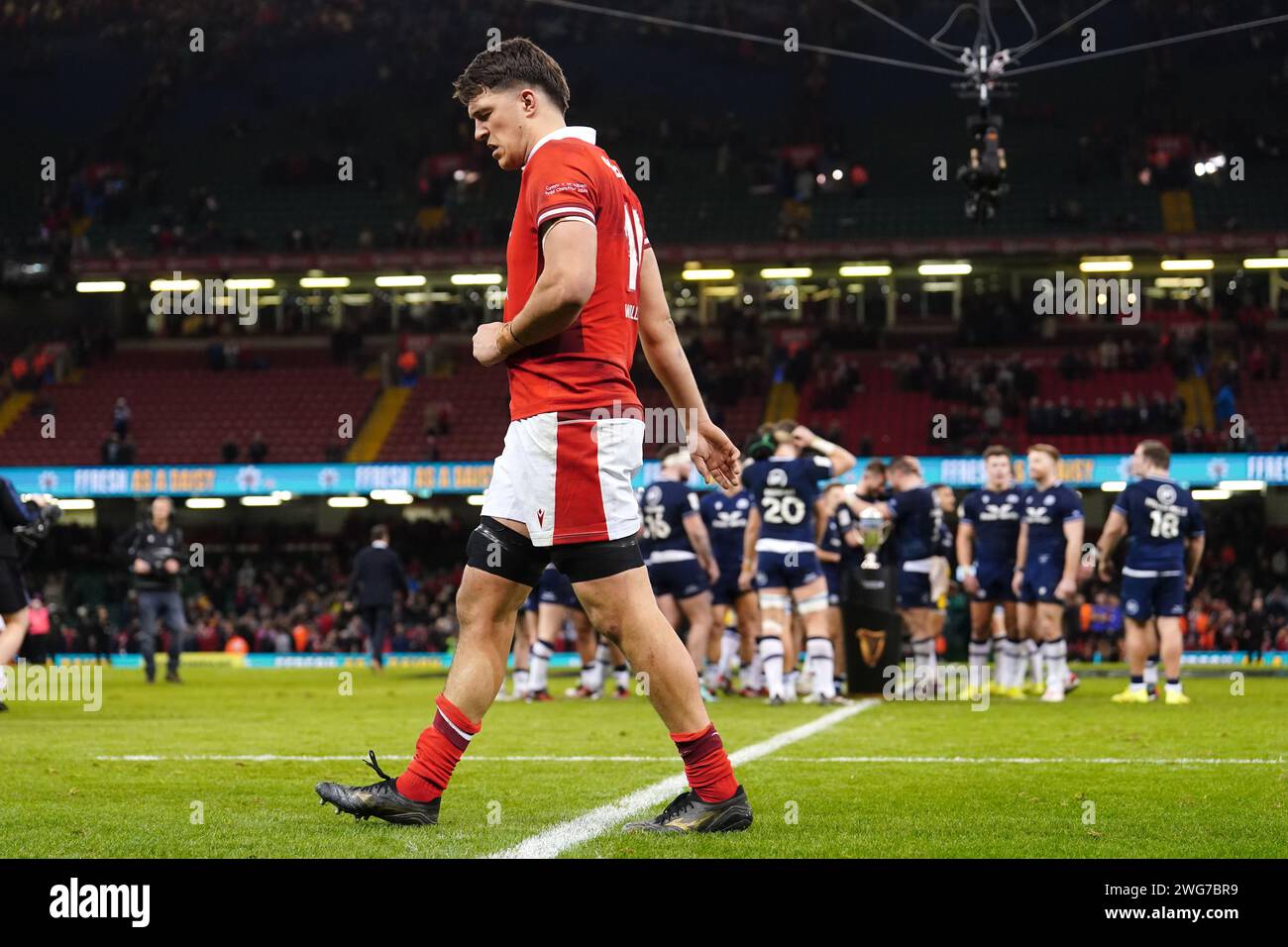 Wales' Teddy Williams walks past as Scotland players celebrate with the ...