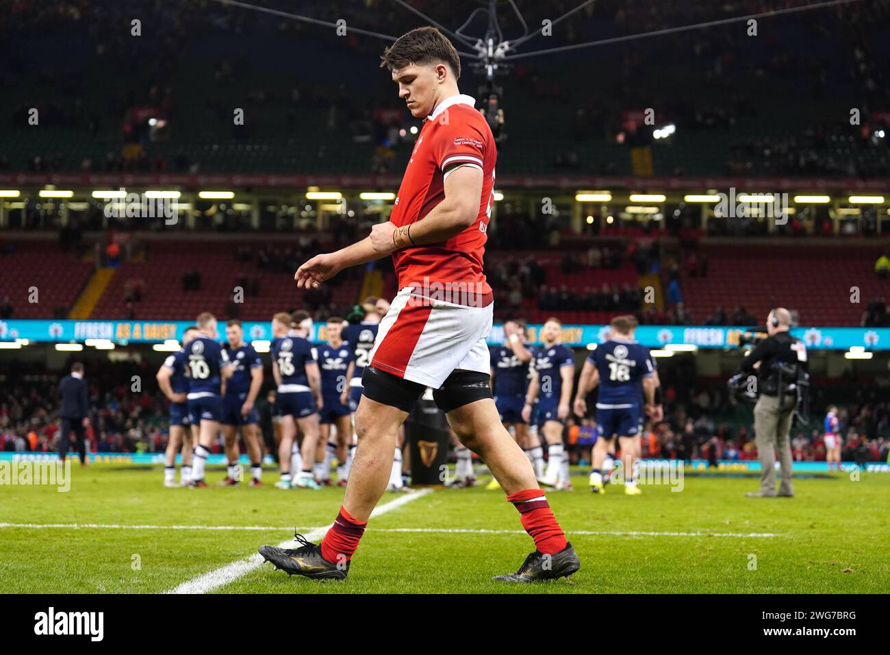 Wales' Teddy Williams walks past as Scotland players celebrate with the ...