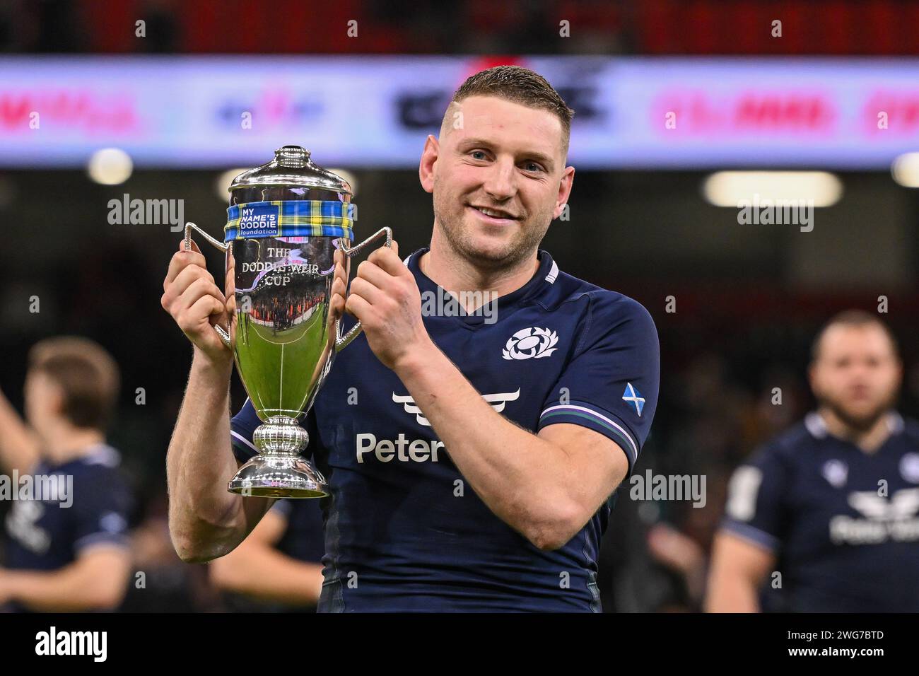 Finn Russell of Scotland lift the Doddie Weir Cup after beating Wales ...
