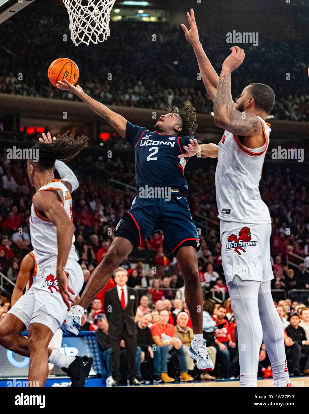 UConn guard Tristen Newton (2) shoots ahead of St. John's center Joel ...