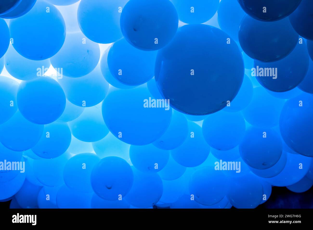 A large group of floating blue toy balloons Stock Photo - Alamy