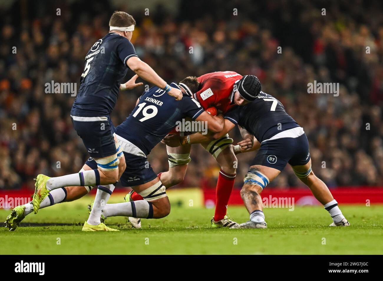 Adam Beard of Wales is tackled by Jamie Ritchie of Scotland and Sam ...