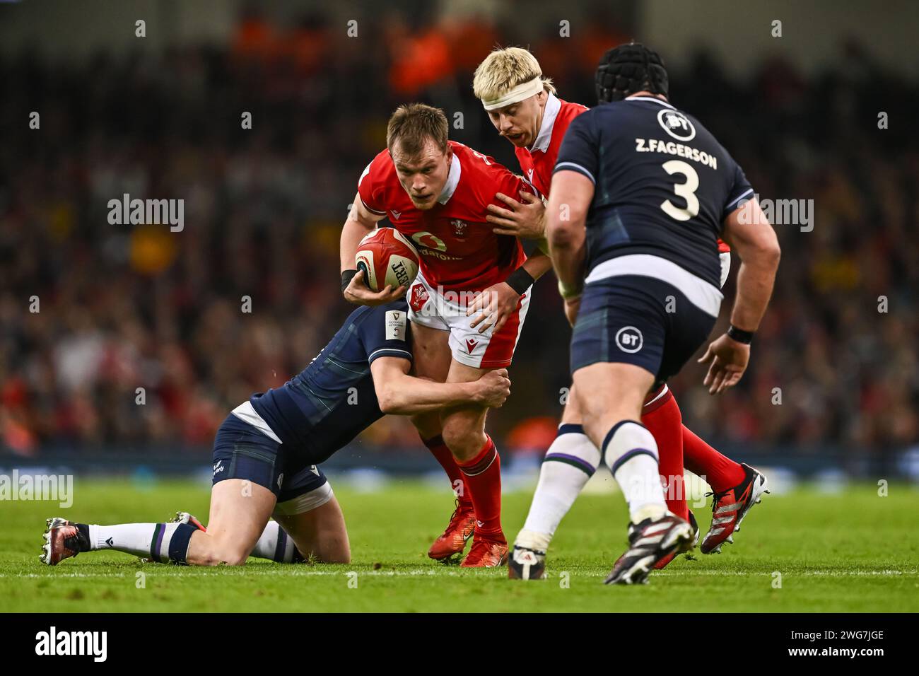 Nick Tompkins of Wales is tackled by Finn Russell of Scotland during ...