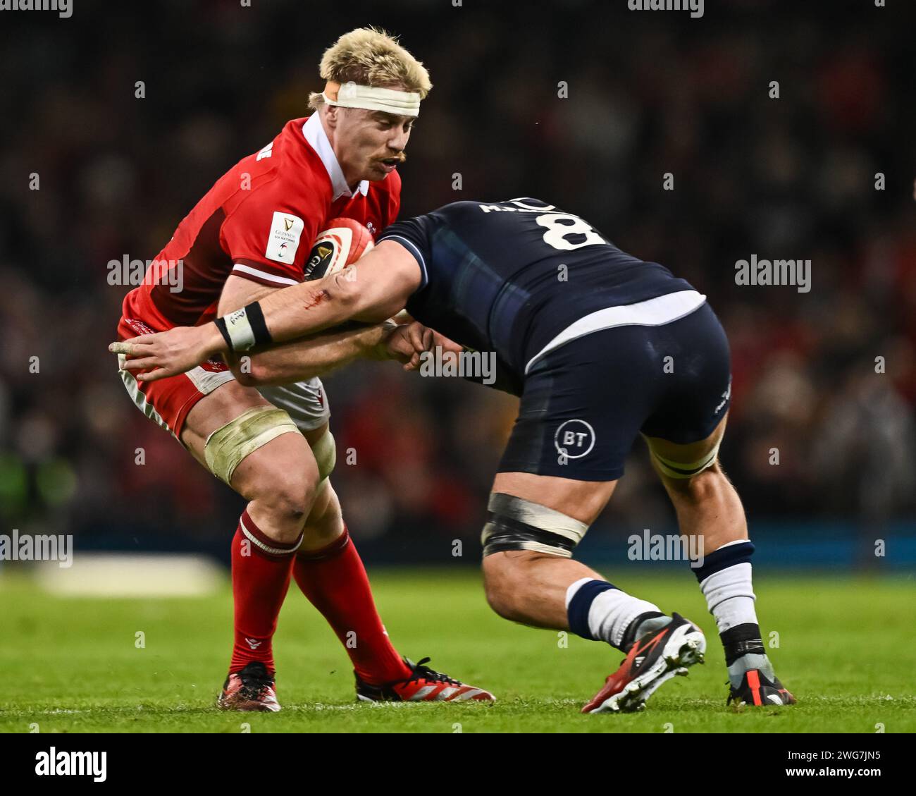 Aaron Wainwright of Wales is tackled by Matt Fagerson of Scotland ...