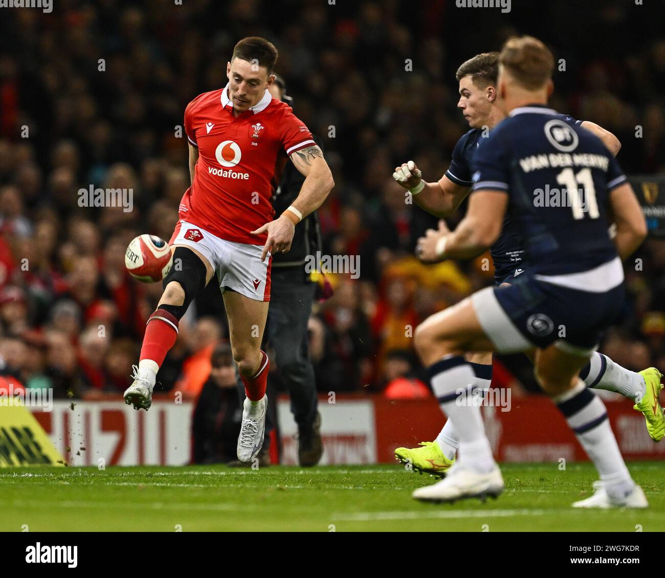 Josh Adams of Wales kicks ahead during the 2024 Guinness 6 Nations ...