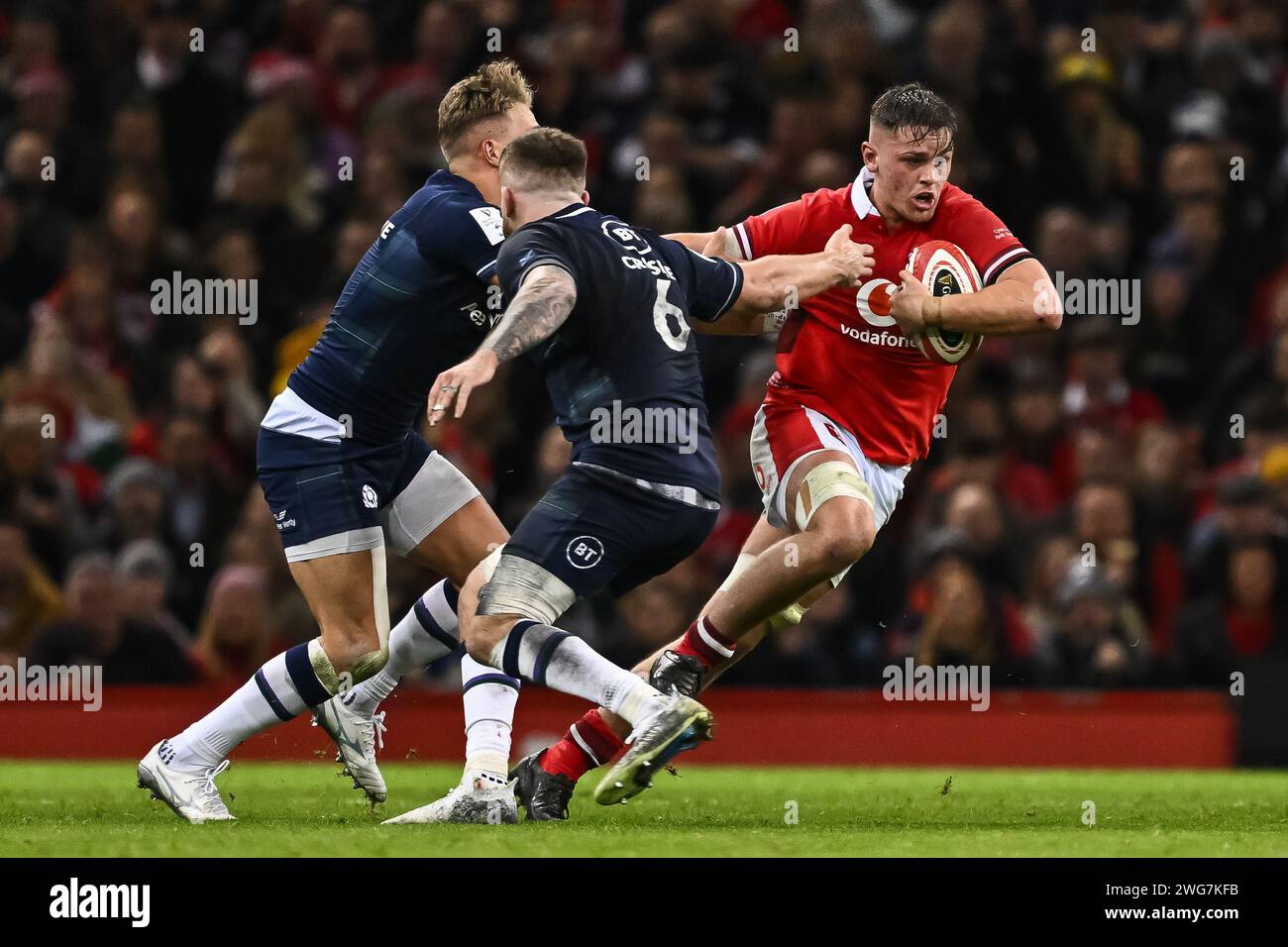 Alex Mann of Wales evades the tackle of Duhan van der Merwe of Scotland ...
