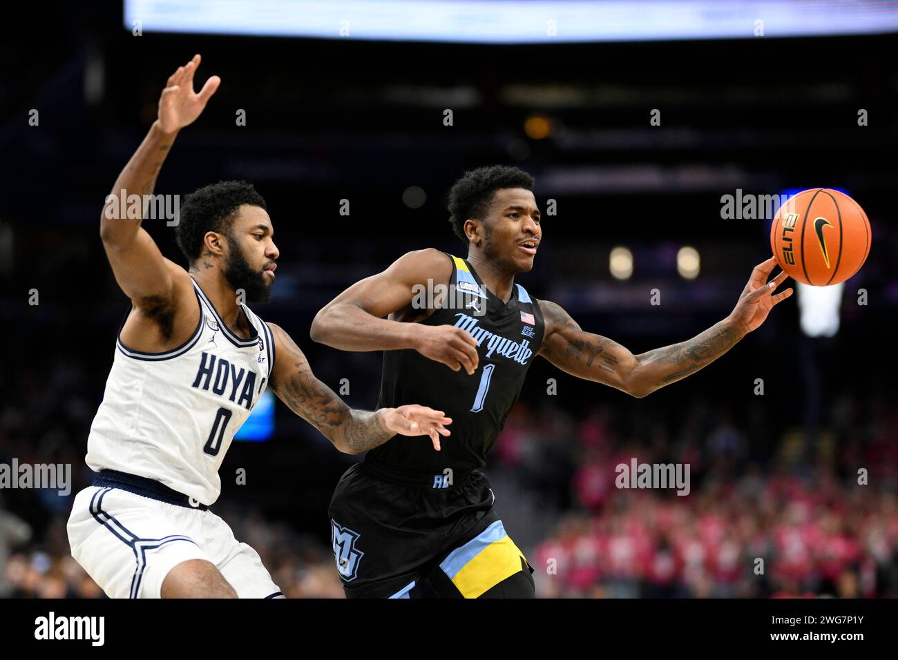 Marquette guard Kam Jones (1) passes off as Georgetown guard Dontrez ...
