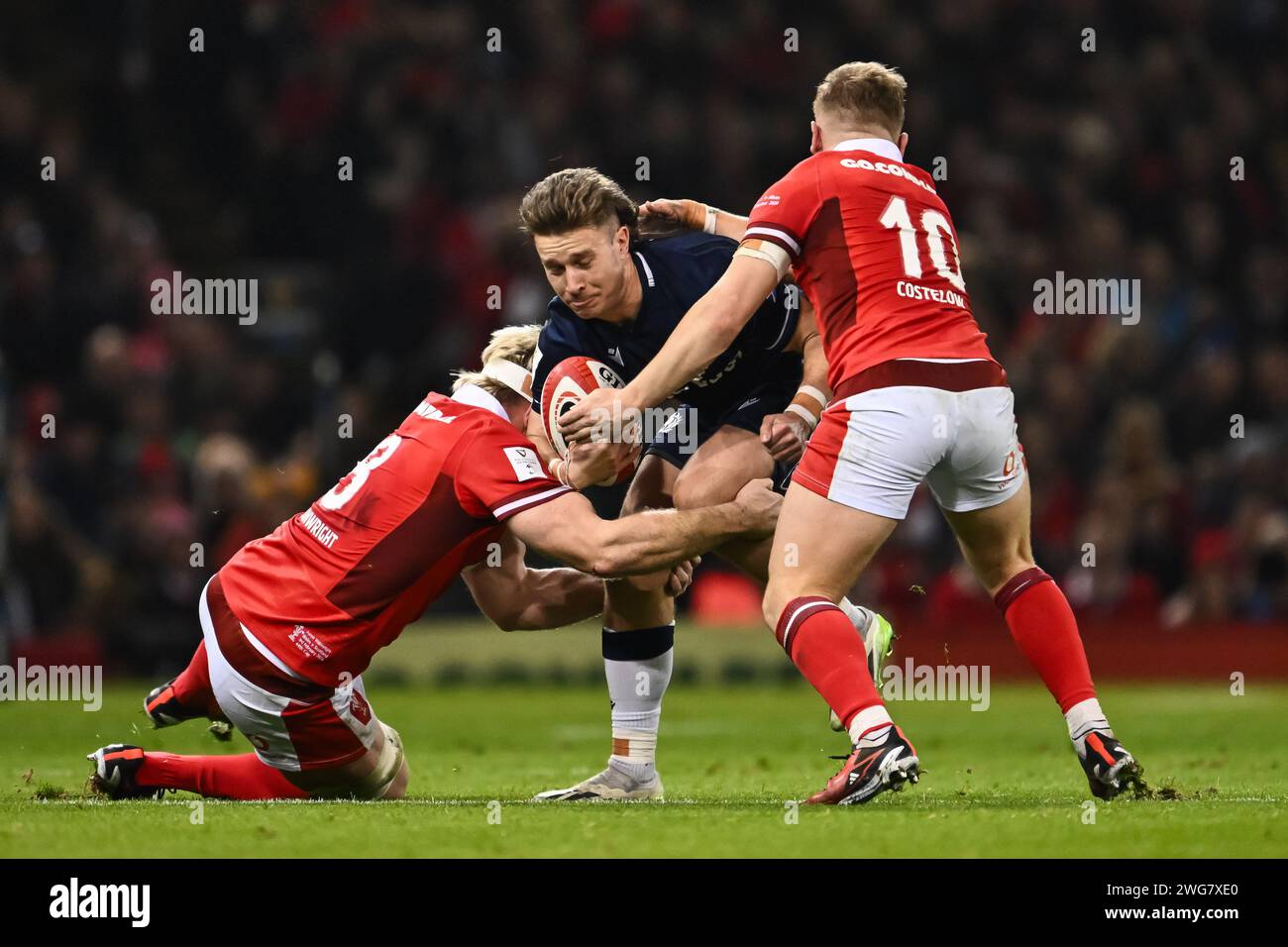 Kyle Rowe of Scotland is tackled by Aaron Wainwright of Wales and Sam ...