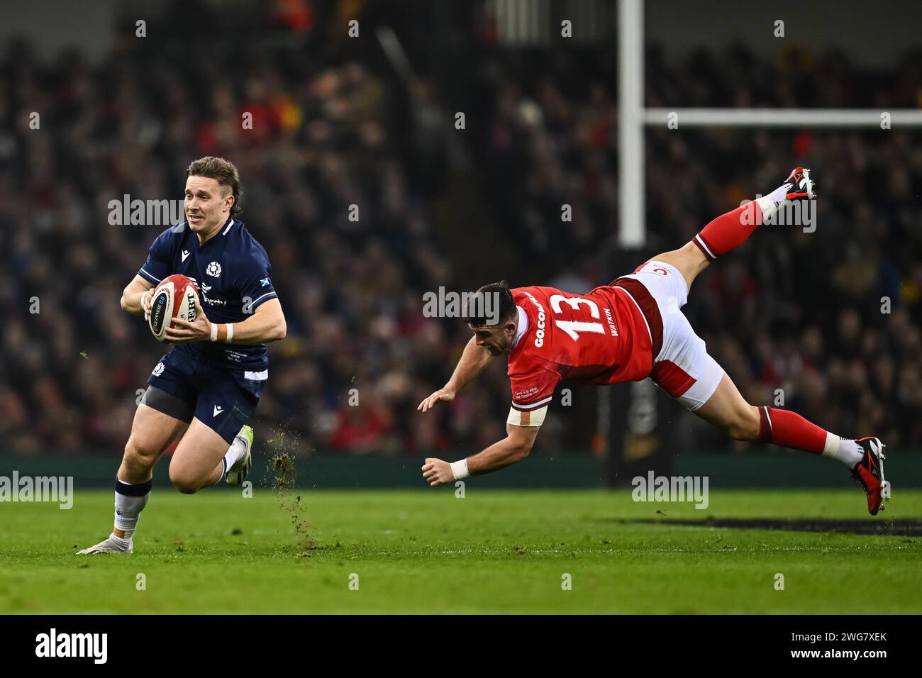 Kyle Rowe of Scotland evades the tackle of Owen Watkin of Wales during ...