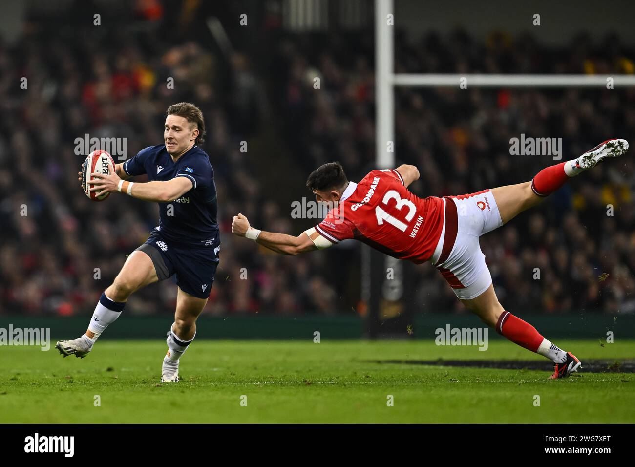 Kyle Rowe of Scotland evades the tackle of Owen Watkin of Wales during ...
