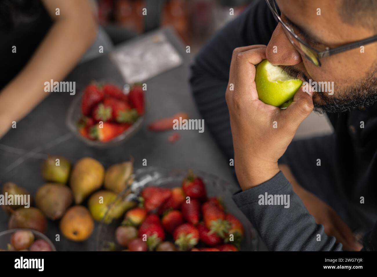 young man eating an exquisite apple, fresh fruits and lifestyle ...