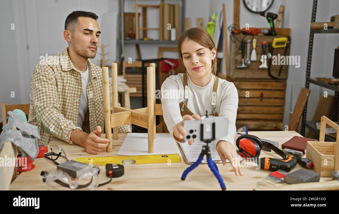 A woman and a man collaborate in a cluttered woodworking workshop ...