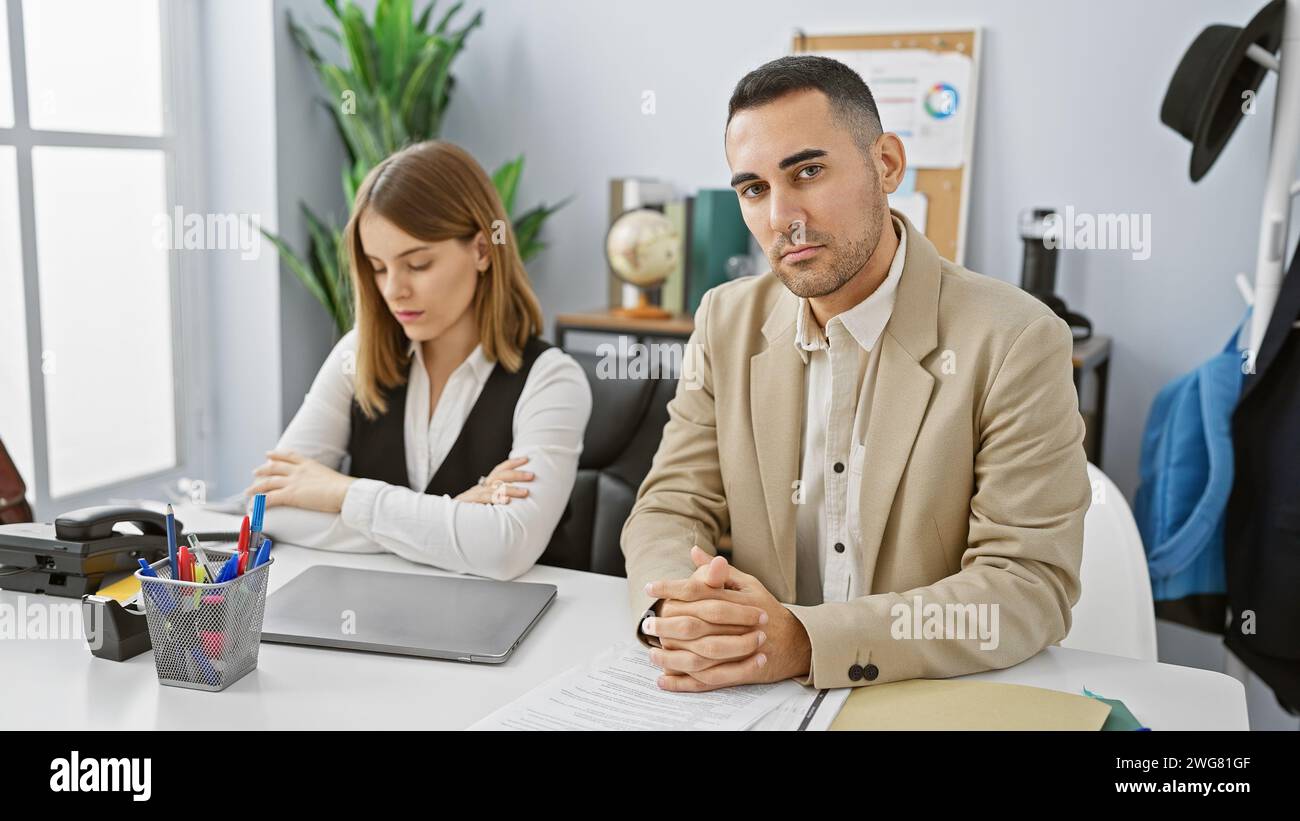 Focused woman and watchful man, co-workers in a modern office ...