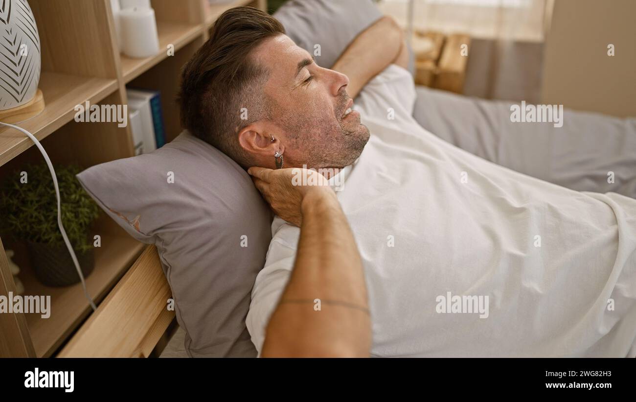 Exhausted young hispanic man, a portrait of worry, lying in his bed ...