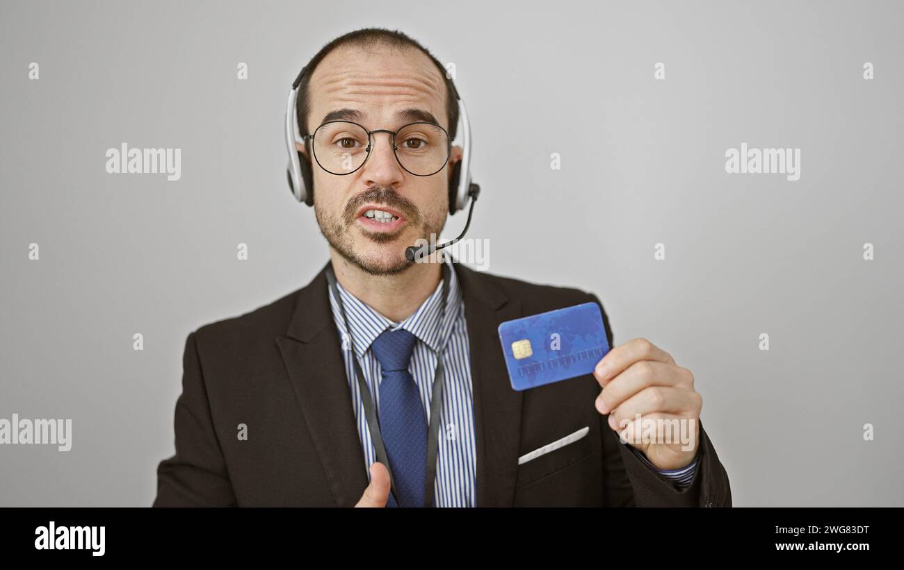 Professional bald hispanic man in suit showing credit card on white ...