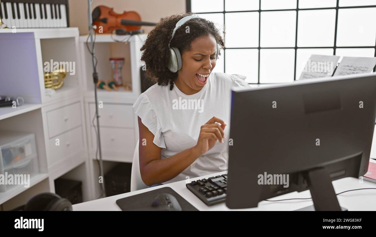 African american woman with braids singing joyfully in a music studio ...