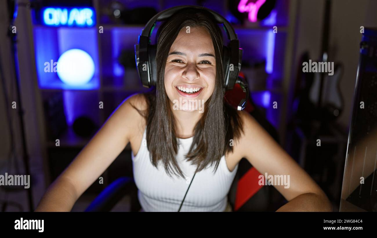 Young beautiful hispanic woman streamer playing video game using ...