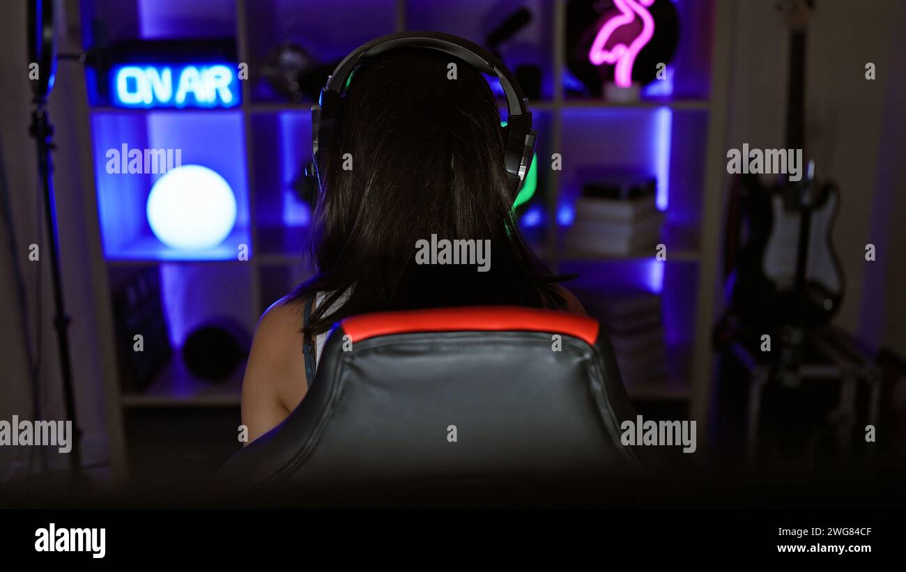 Backwards-sitting young, beautiful hispanic woman streamer brings the ...