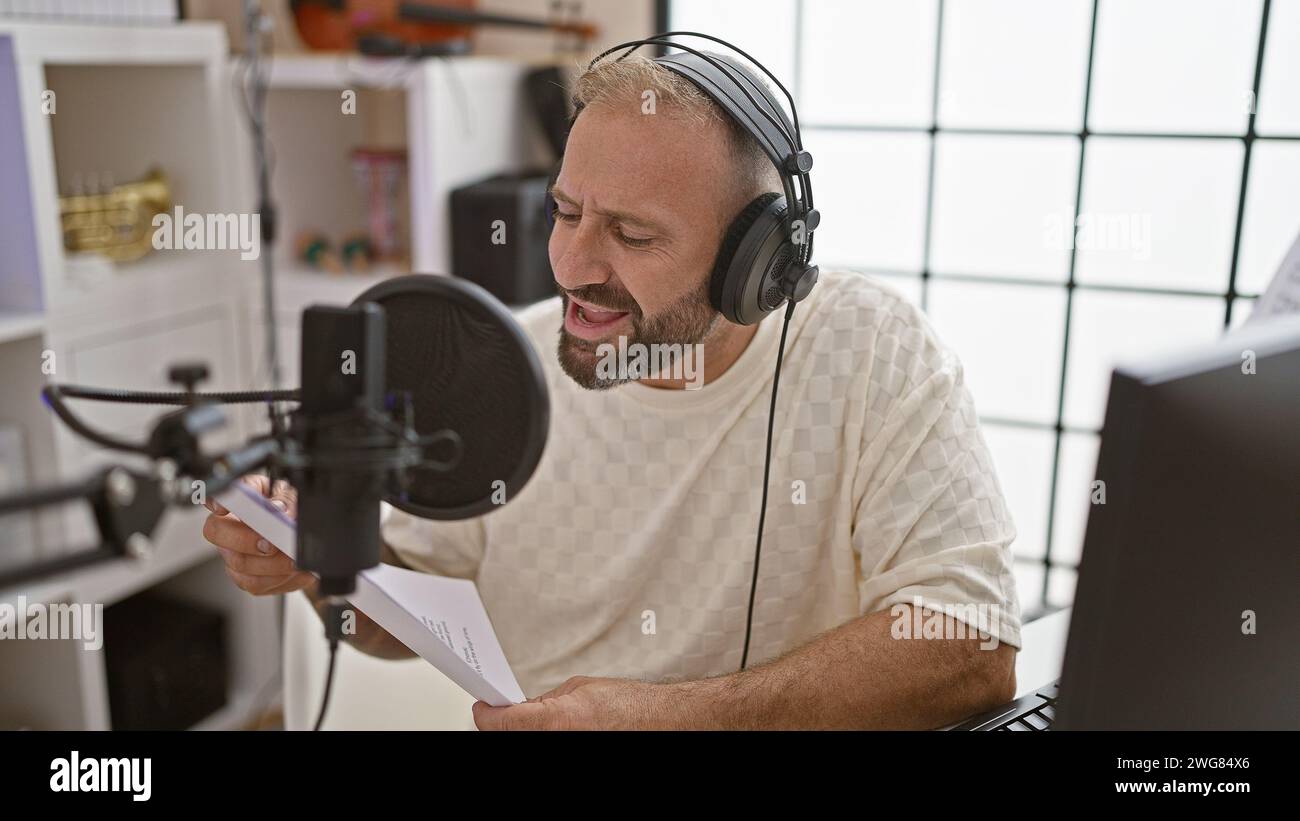 Handsome young man, an acoustic music artist, passionately singing a ...