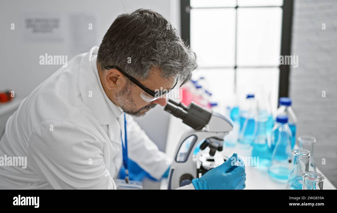 Attractive grey-haired young hispanic man, a dedicated scientist ...