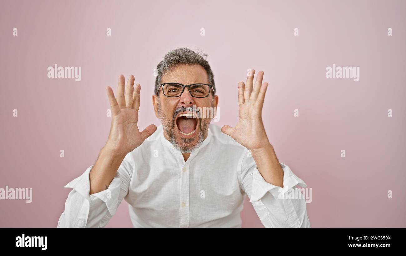 Young, attractive hispanic man, grey-haired and bearded, screaming loud ...